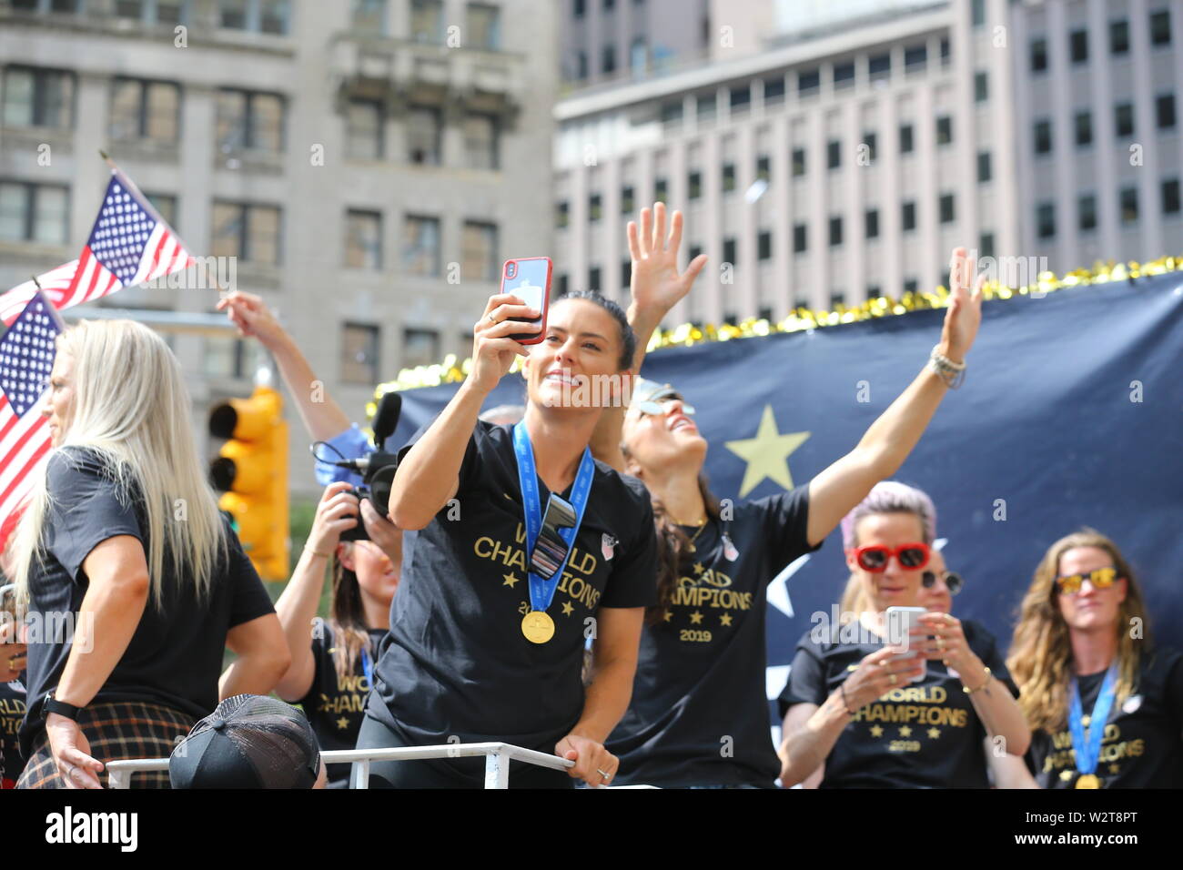 NEW YORK, NEW YORK - JUNE 30: Ali Krieger takes photos of the crowds as ...