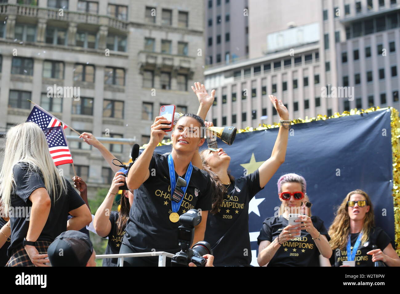 NEW YORK, NEW YORK - JUNE 30: Ali Krieger takes photos of the crowds as ...