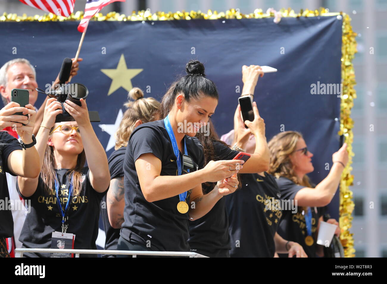 NEW YORK, NEW YORK - JUNE 30: Ali Krieger takes photos of the crowds as ...