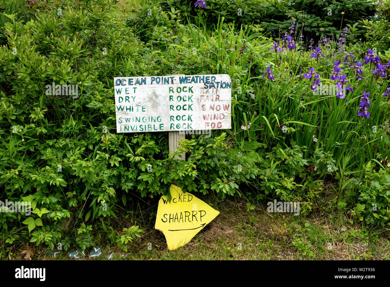 A humorous weather forecasting sign decorates a garden at Ocean Point ...