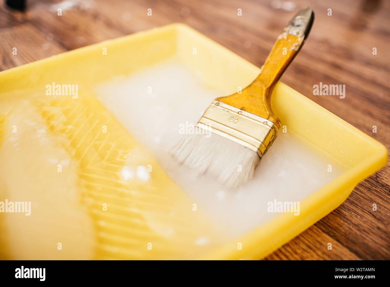Paintbrush and glue container on concrete surface. Composition tools ...