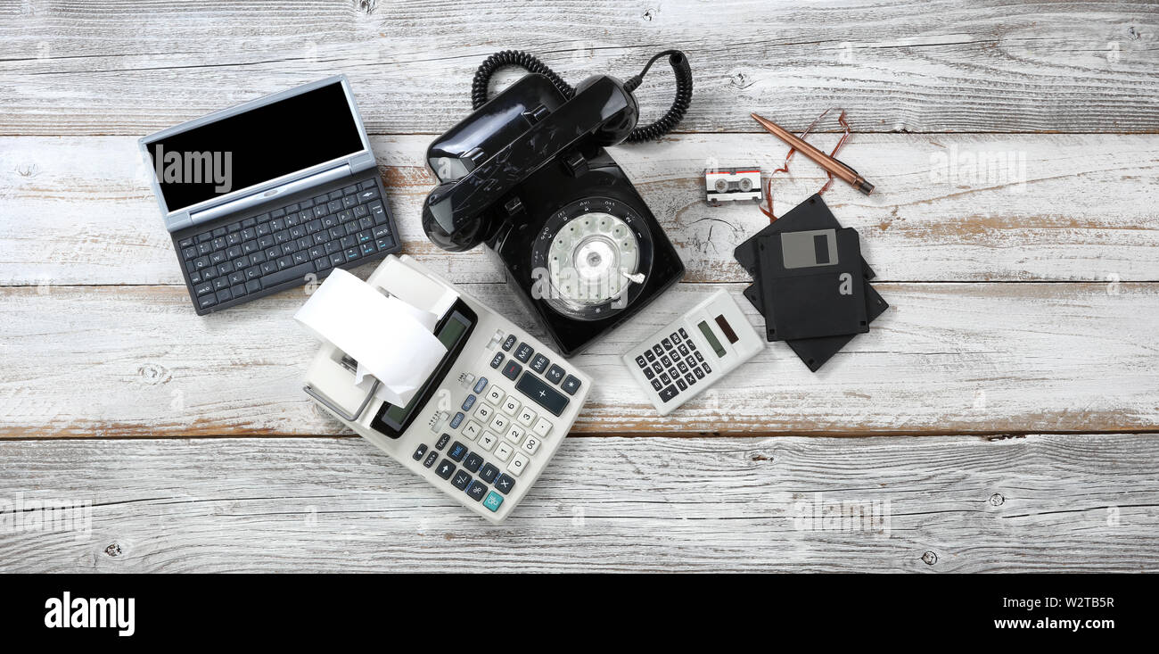 Overhead view of obsolete technologies that includes rotary dial phone ...