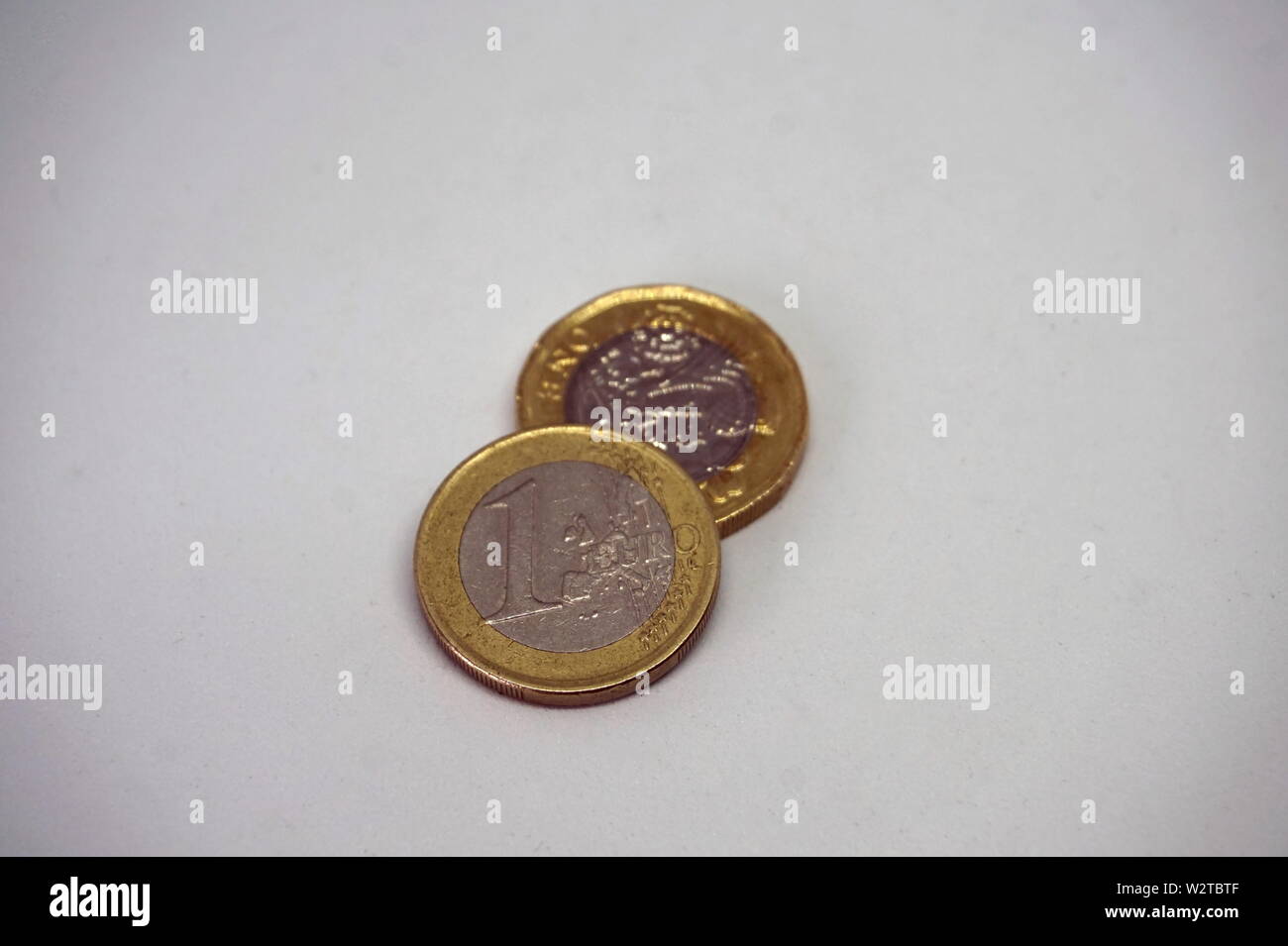 A one Euro and one Pound Coins Stock Photo - Alamy