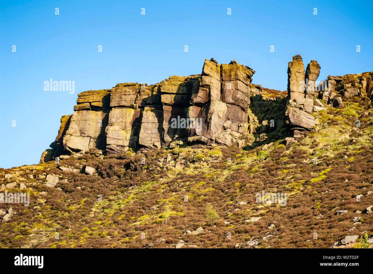 Distinctive gritstone outcrop high above Dove Stone Reservoir near ...