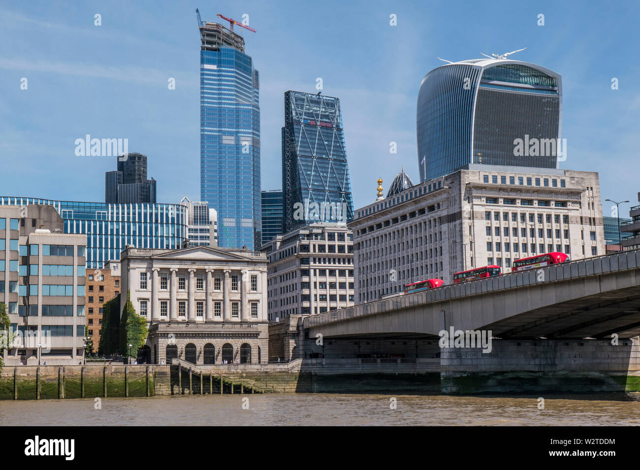 London Bridge with Red London Buses leading to City of London Financial ...