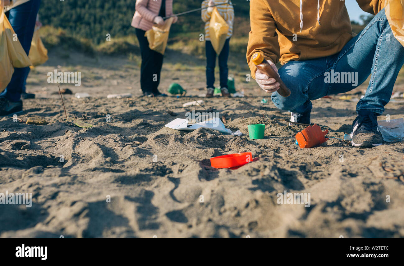 Young man cleaning the beach Stock Photo - Alamy