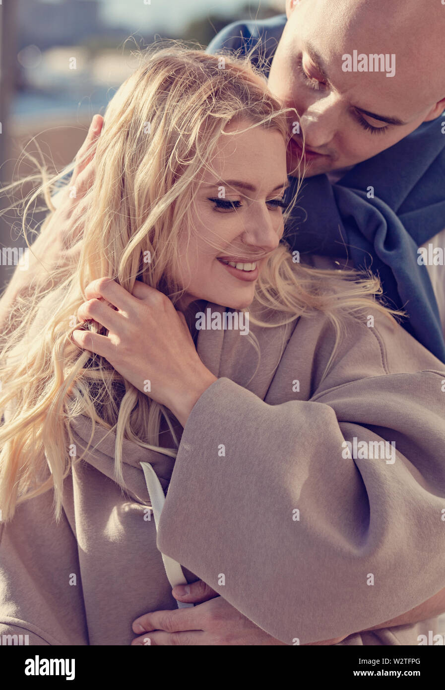 Beautiful laughing couple hugging with love and touching each other to ...