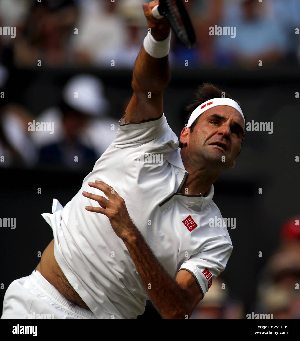 Wimbledon, UK. 10th July, 2019. Roger Federer serving during his ...