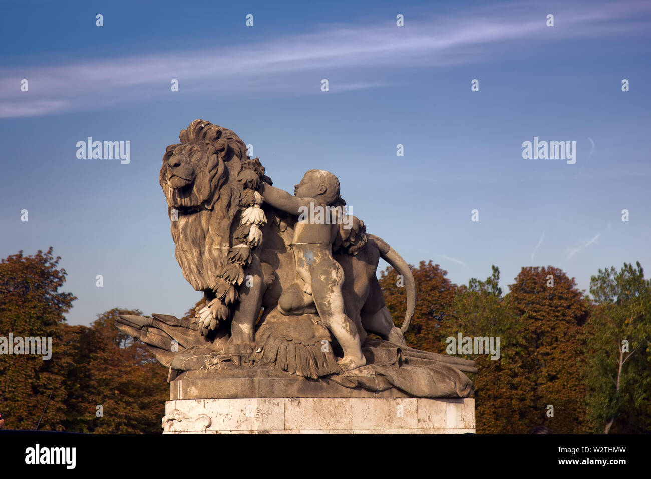 statue of a lion and a baby crowning a formidable beast with a wreath ...