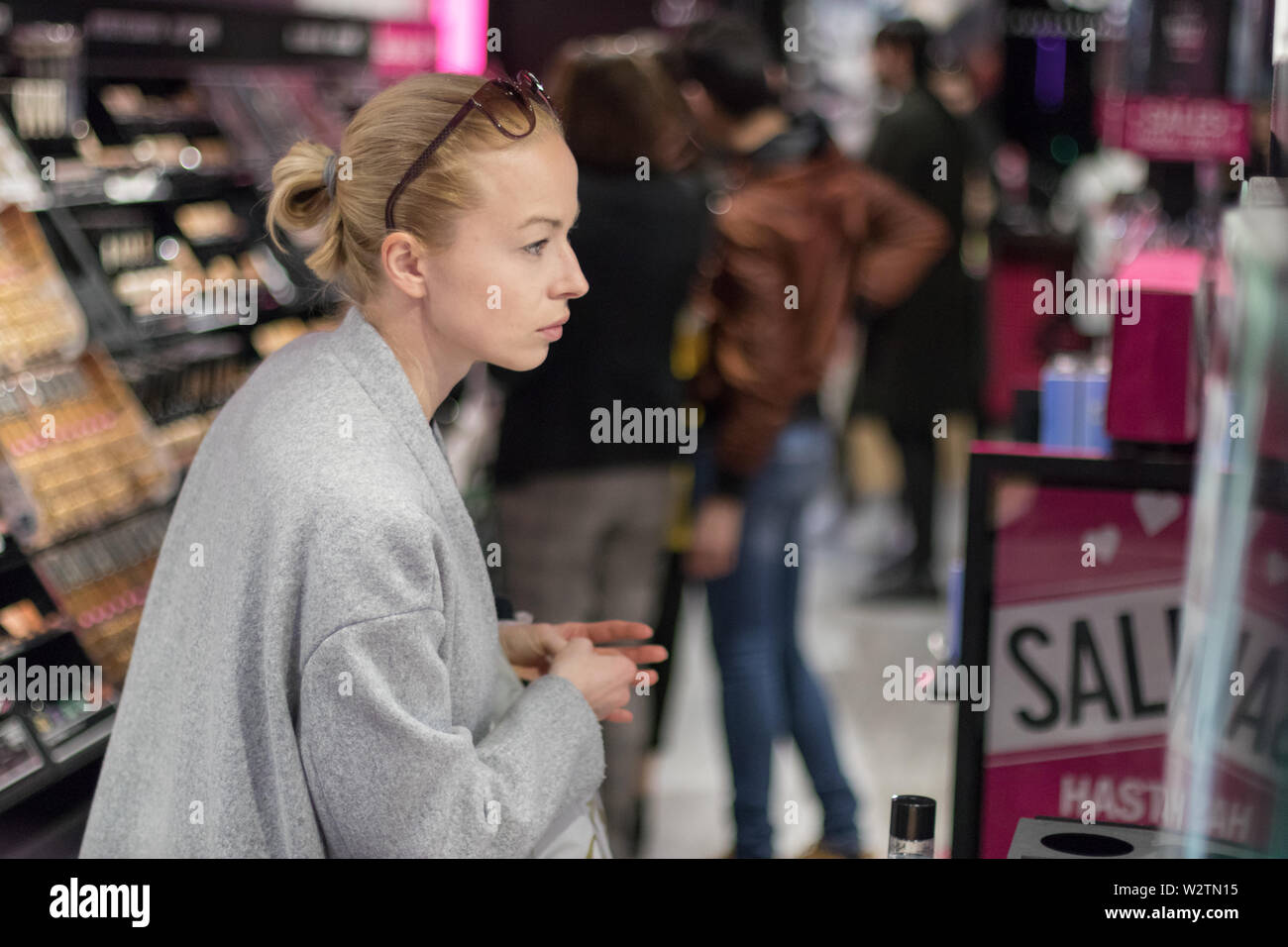Women buying and testing cosmetics in a beauty store Stock Photo - Alamy