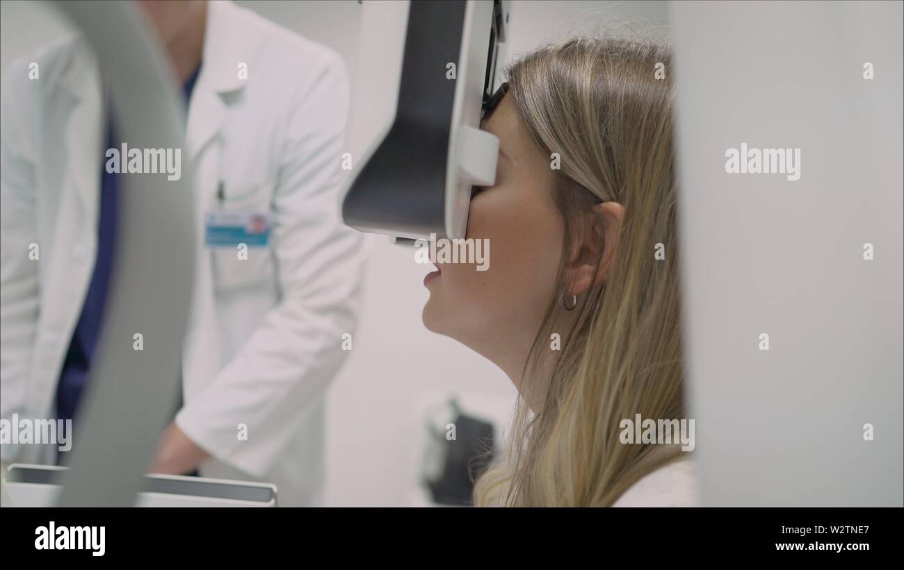 A beautiful girl is undergoing an ophthalmologic examination, checking ...