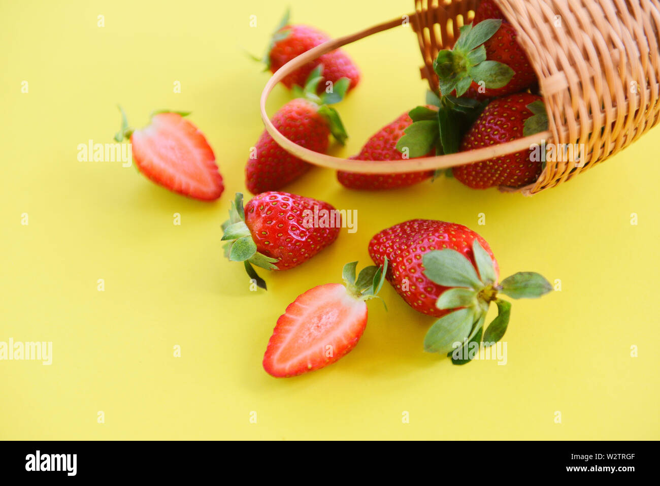 strawberries fresh on yellow background / ripe red strawberry picking ...