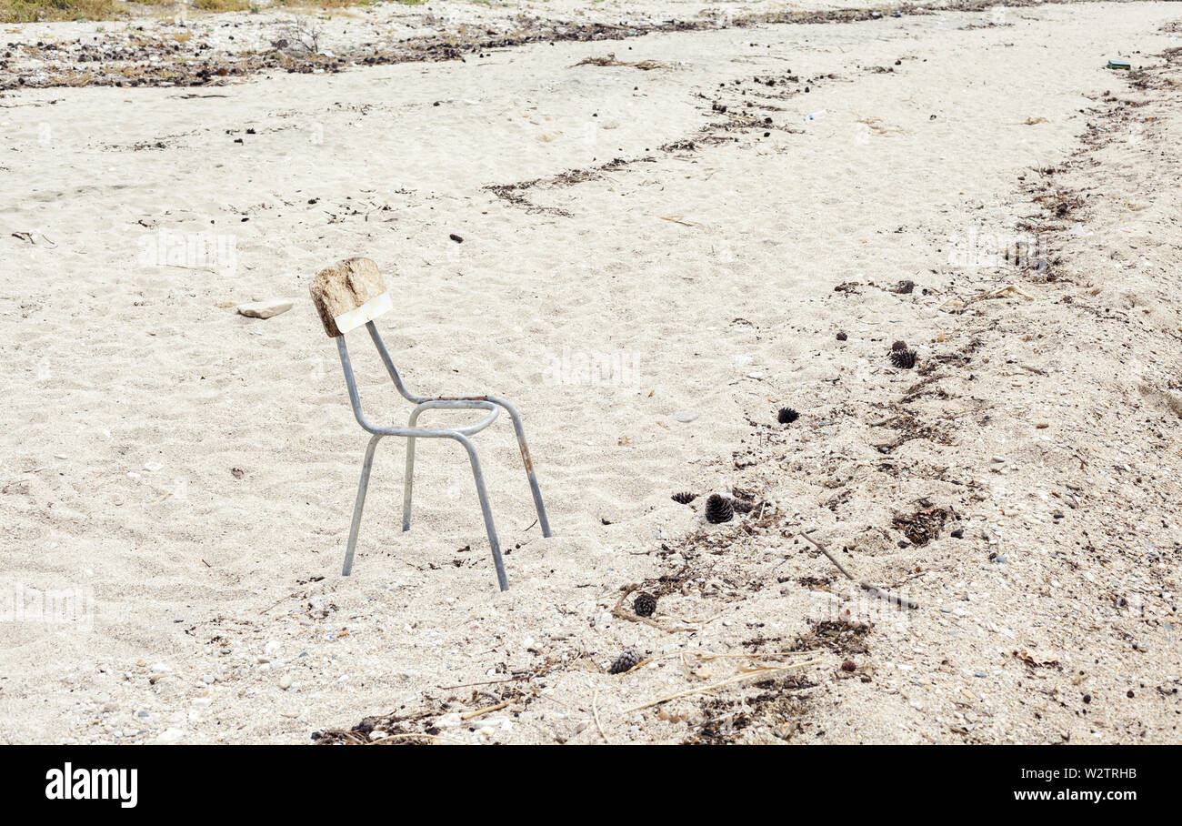 Environmental pollution in the beach, rusty metal chairs thrown on the ...