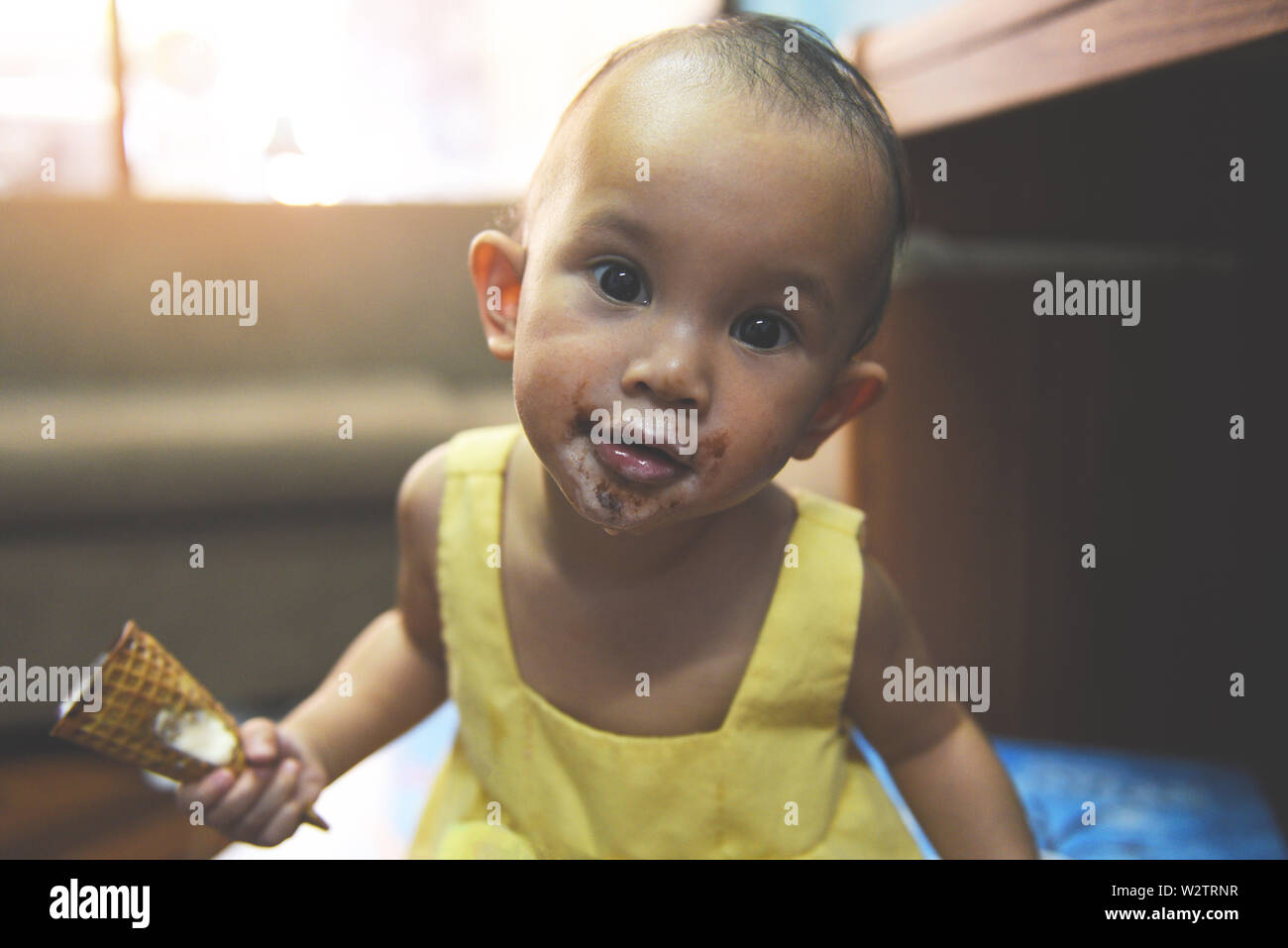 Child eating ice cream / Funny Asian baby girl happy holding ice cream ...