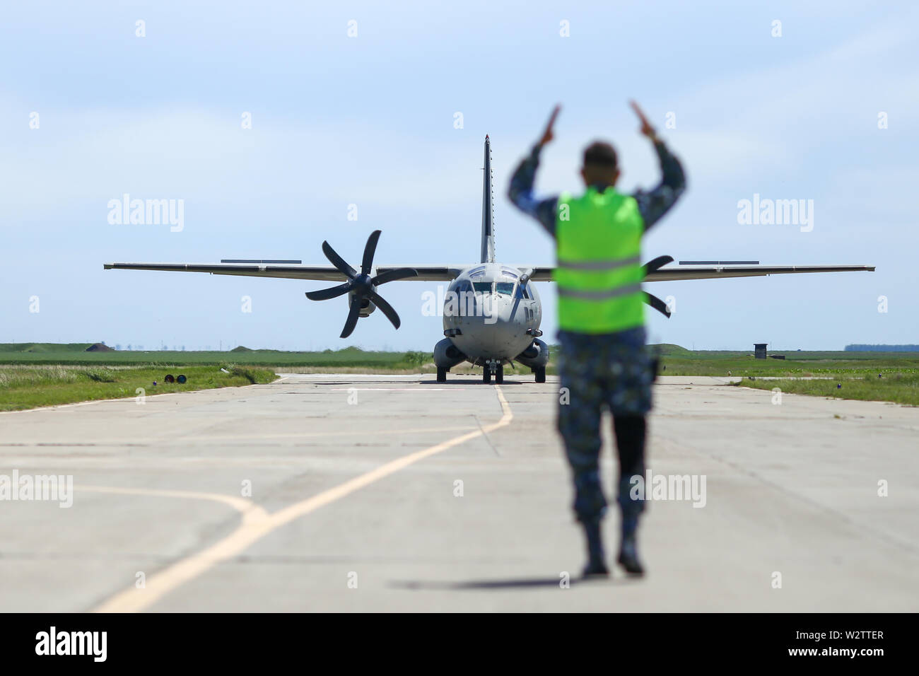 Boboc, Romania - May 22, 2019: Ground personnel is aircraft marshalling ...