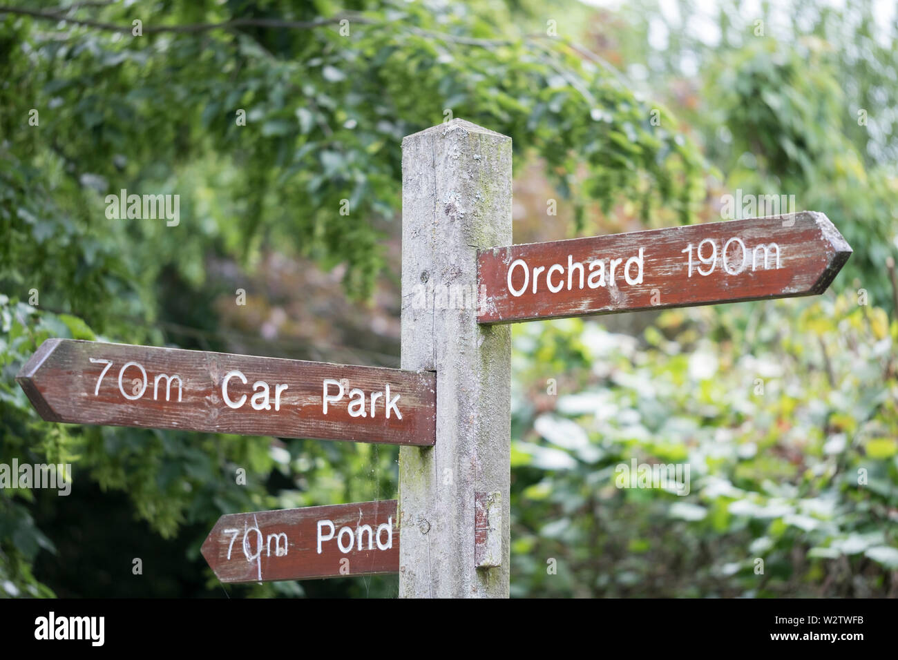 Signpost to the orchard, car park and pond in Shenley Park Stock Photo ...