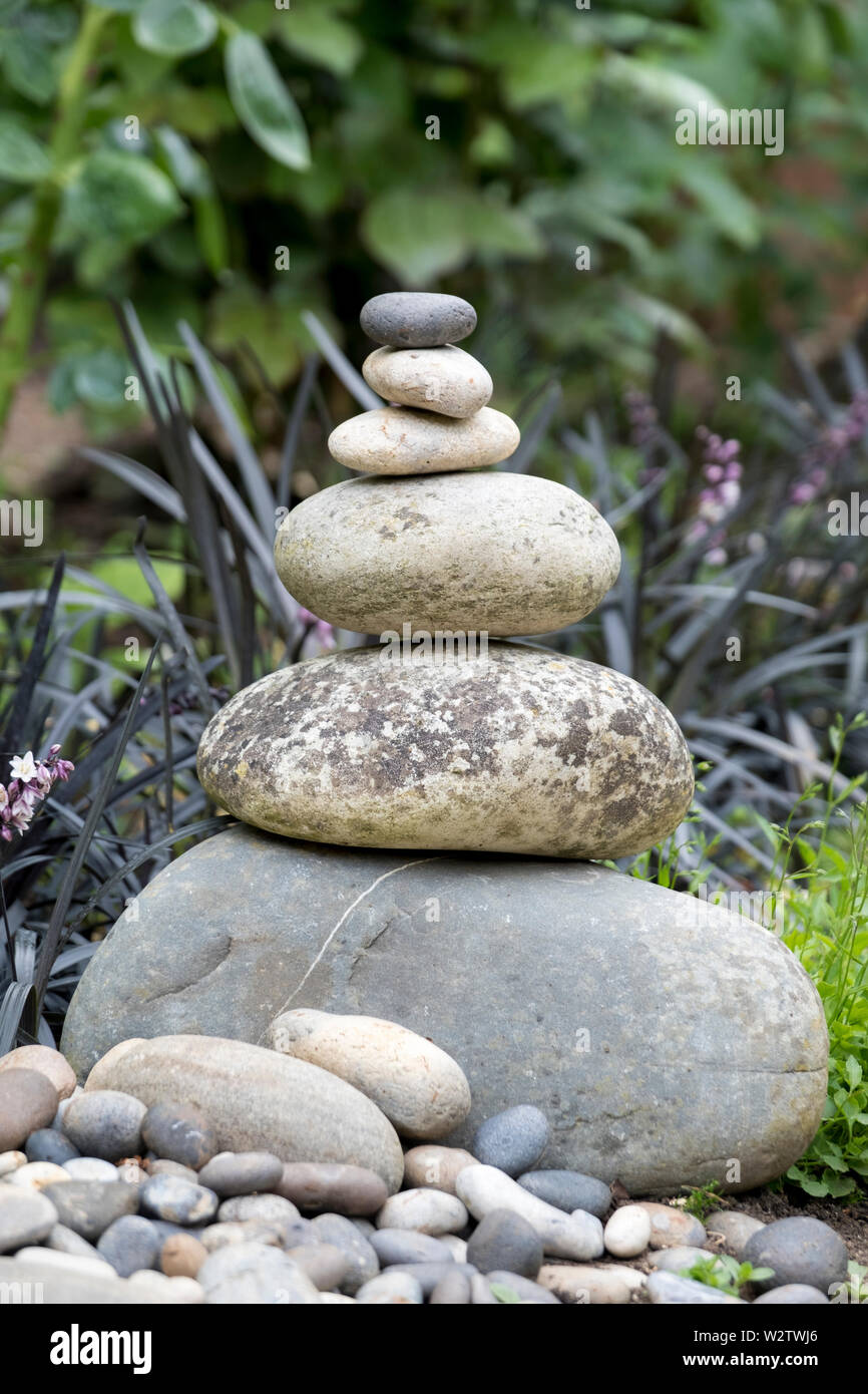 Zen stacked stones. Round pebbles stacked on top of each other in ...