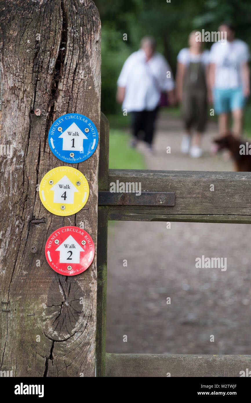 Signs for circular walks with three adults and their dog walking along ...
