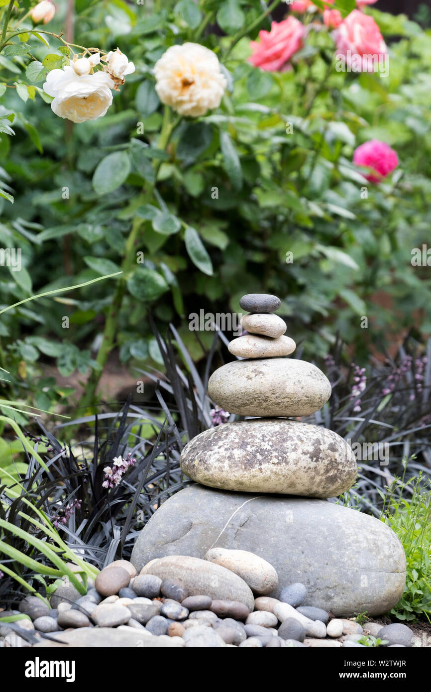 Zen stacked stones. Round pebbles stacked on top of each other in ...