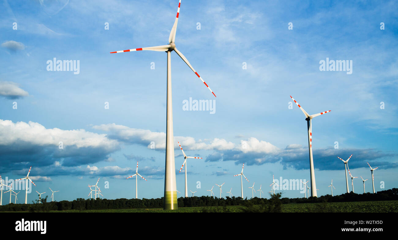 Electric generators turbines in field Stock Photo - Alamy