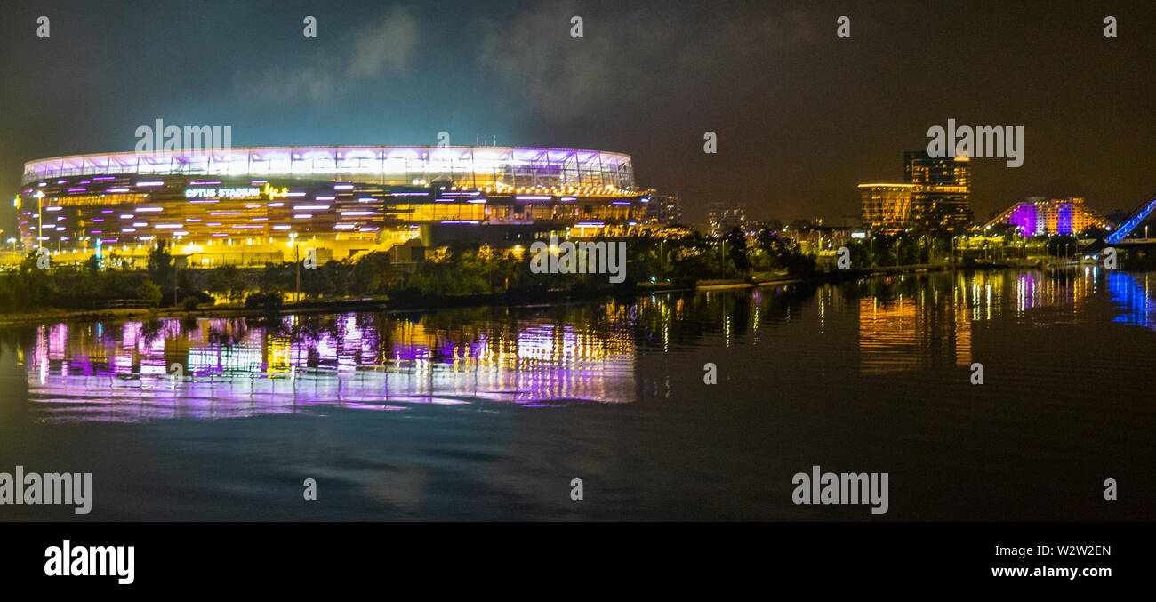 Optus Stadium on the banks of the Swan River lit up at night in ...