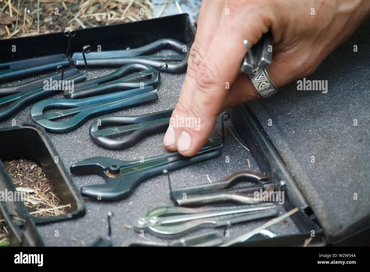 Closeup of a man's hand picks one of jaw harps, khomuses, folk musical ...