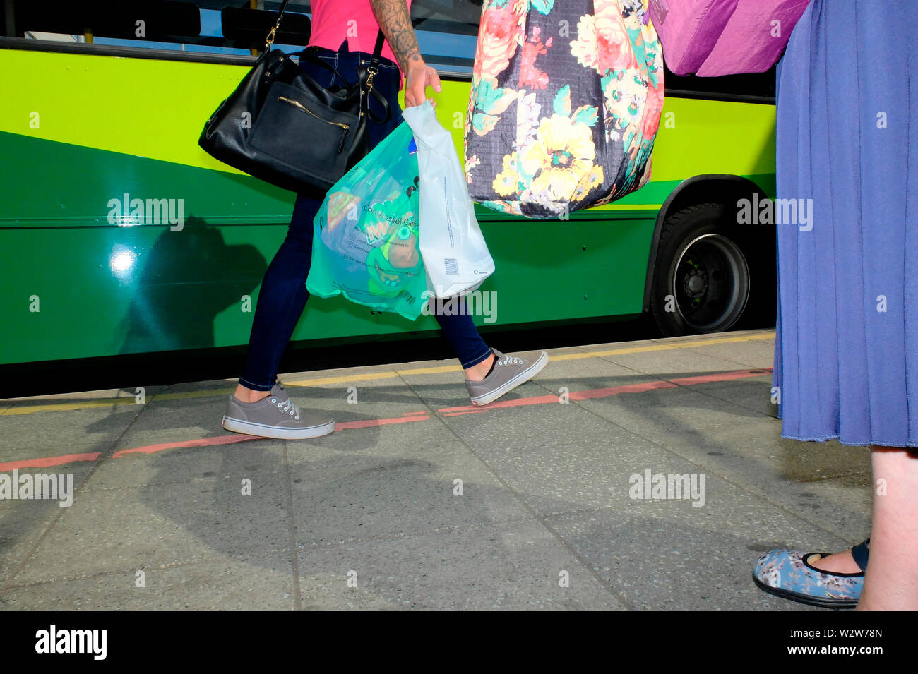 Cutaway images of people in a bus station carrying bags of different ...