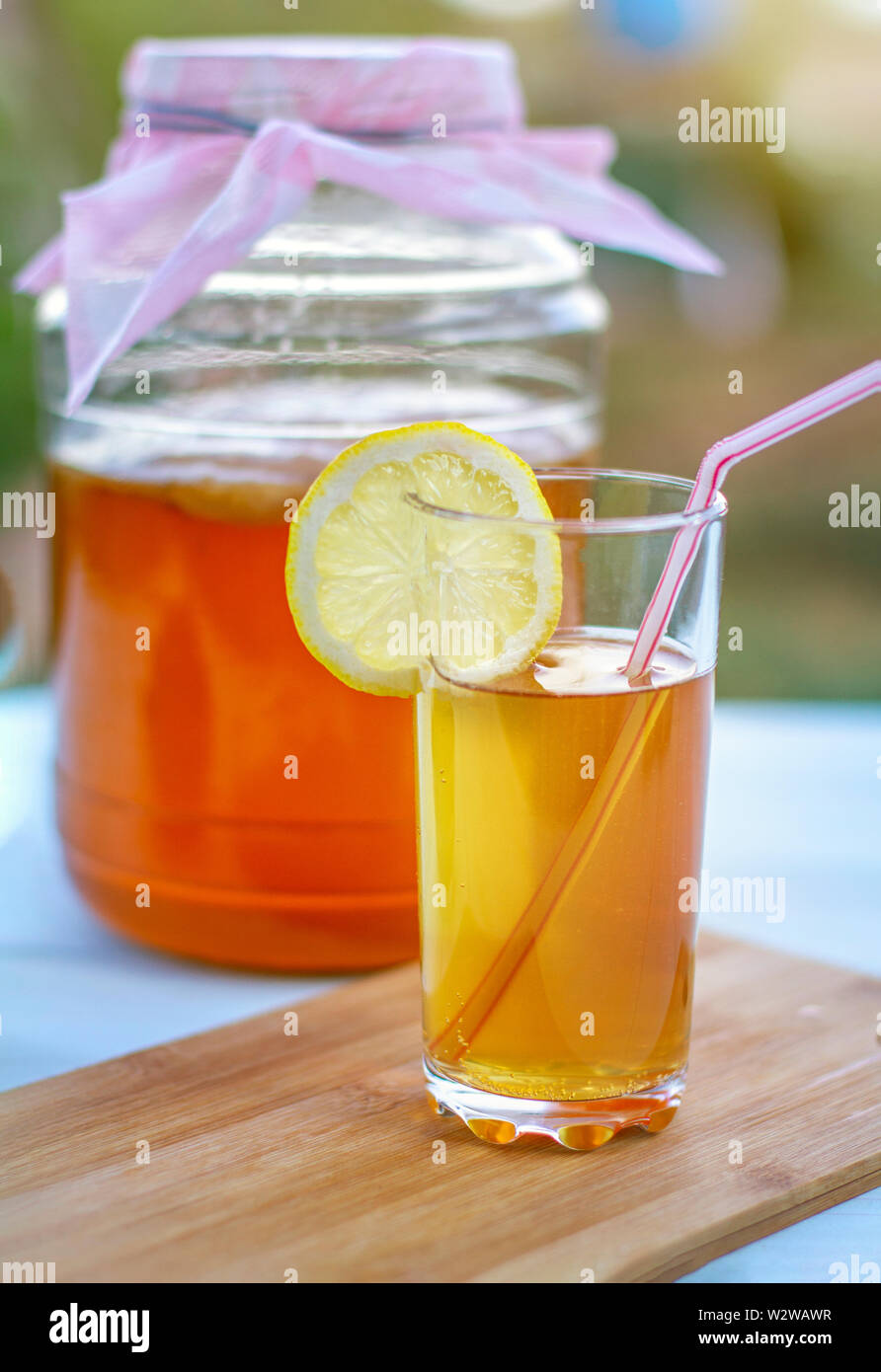 Glass jar with Kombucha, poured glass with Kombucha and raspberries in ...