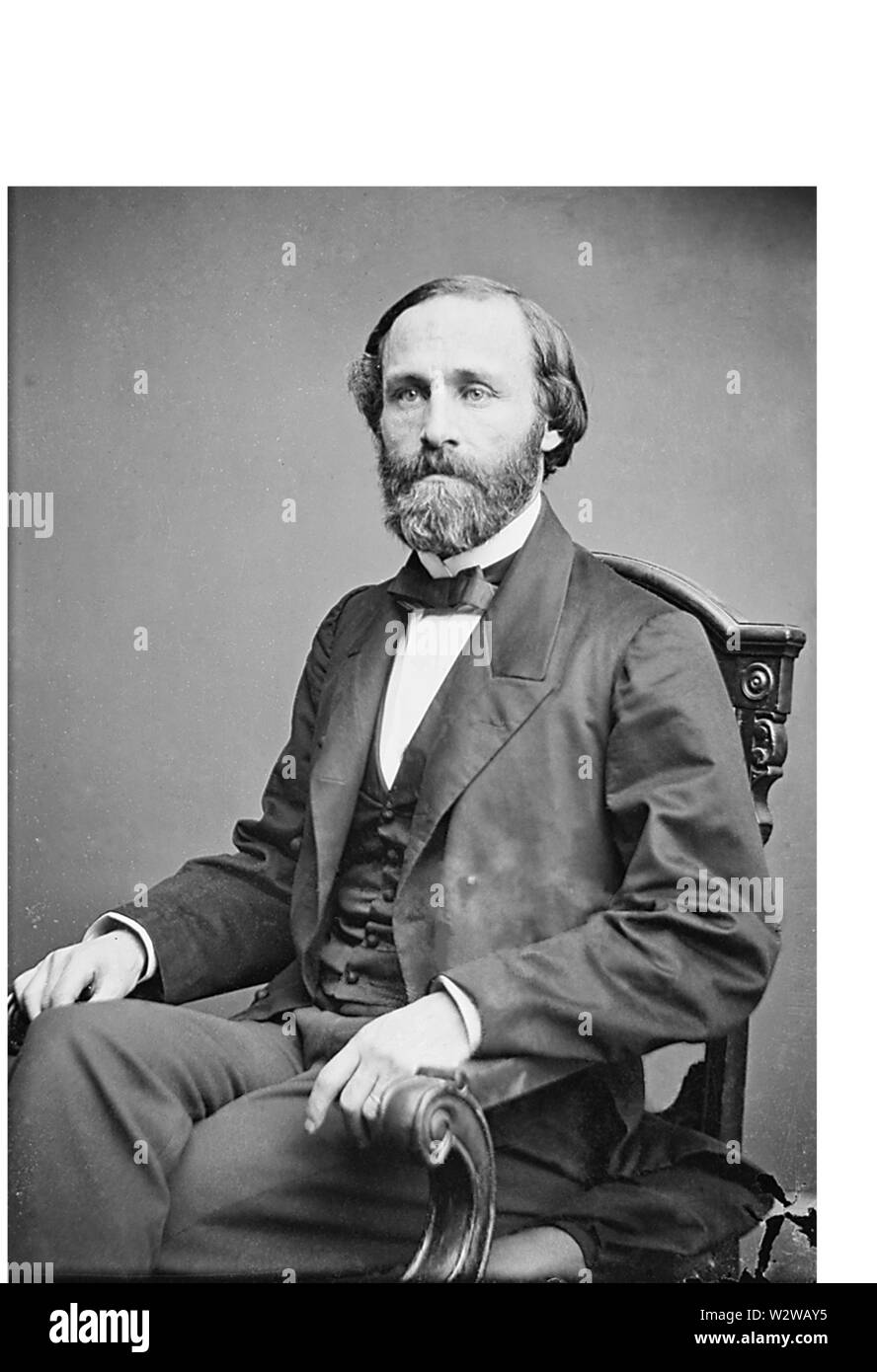 black and white photo of seated man, This version has been cropped down ...