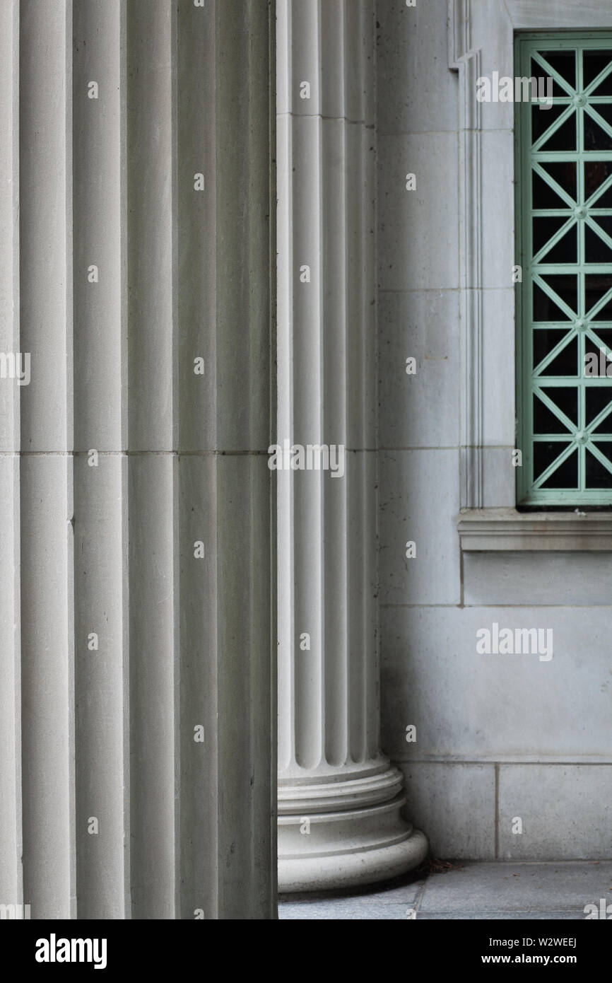 Vertical photo of two columns and partial green grille Stock Photo - Alamy