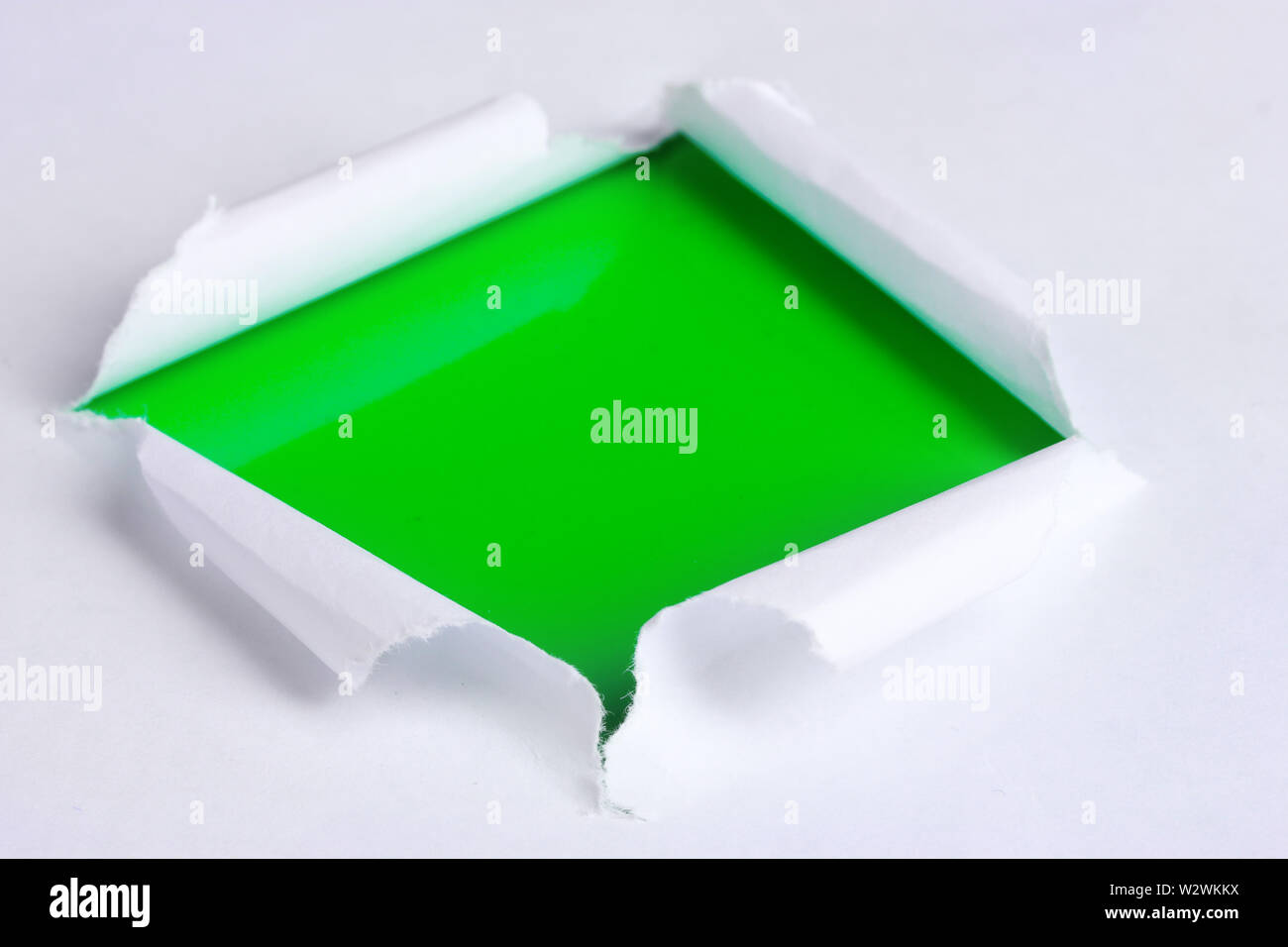 Torn paper with green background Stock Photo - Alamy