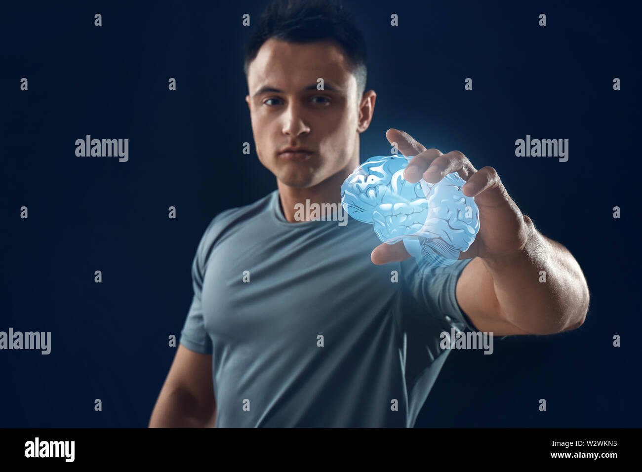 Handsome man with glowing brain on dark background Stock Photo - Alamy