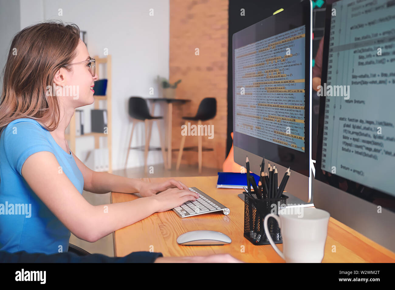 Female programmer working in office Stock Photo - Alamy