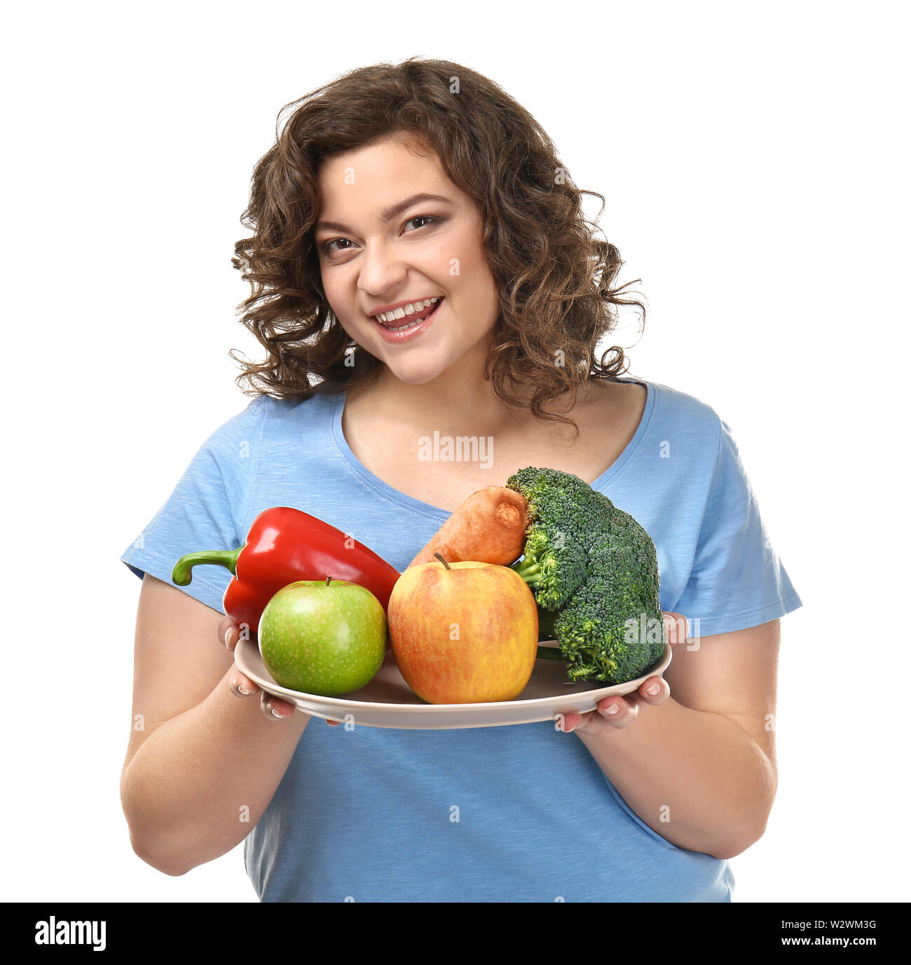 Overweight woman with fruit and vegetables on white background. Weight ...