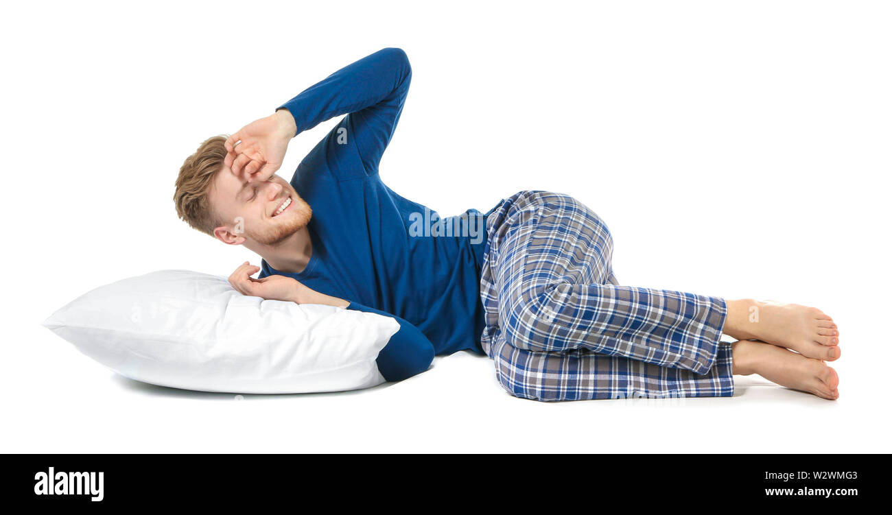 Handsome sleepy man with pillow on white background Stock Photo - Alamy