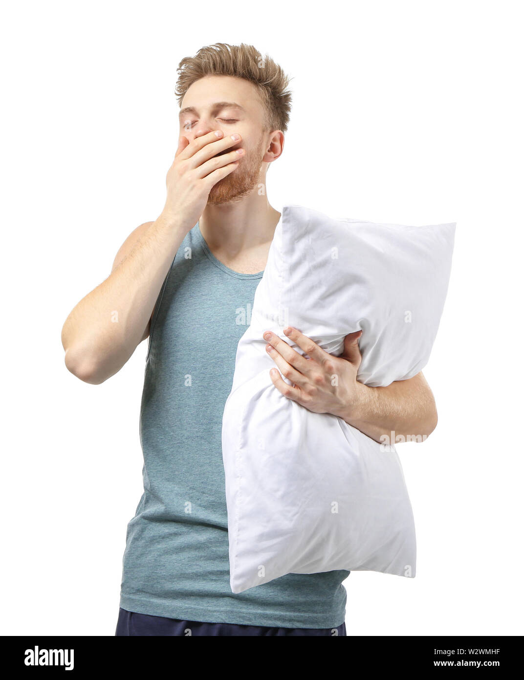 Sleepy man with pillow on white background Stock Photo - Alamy
