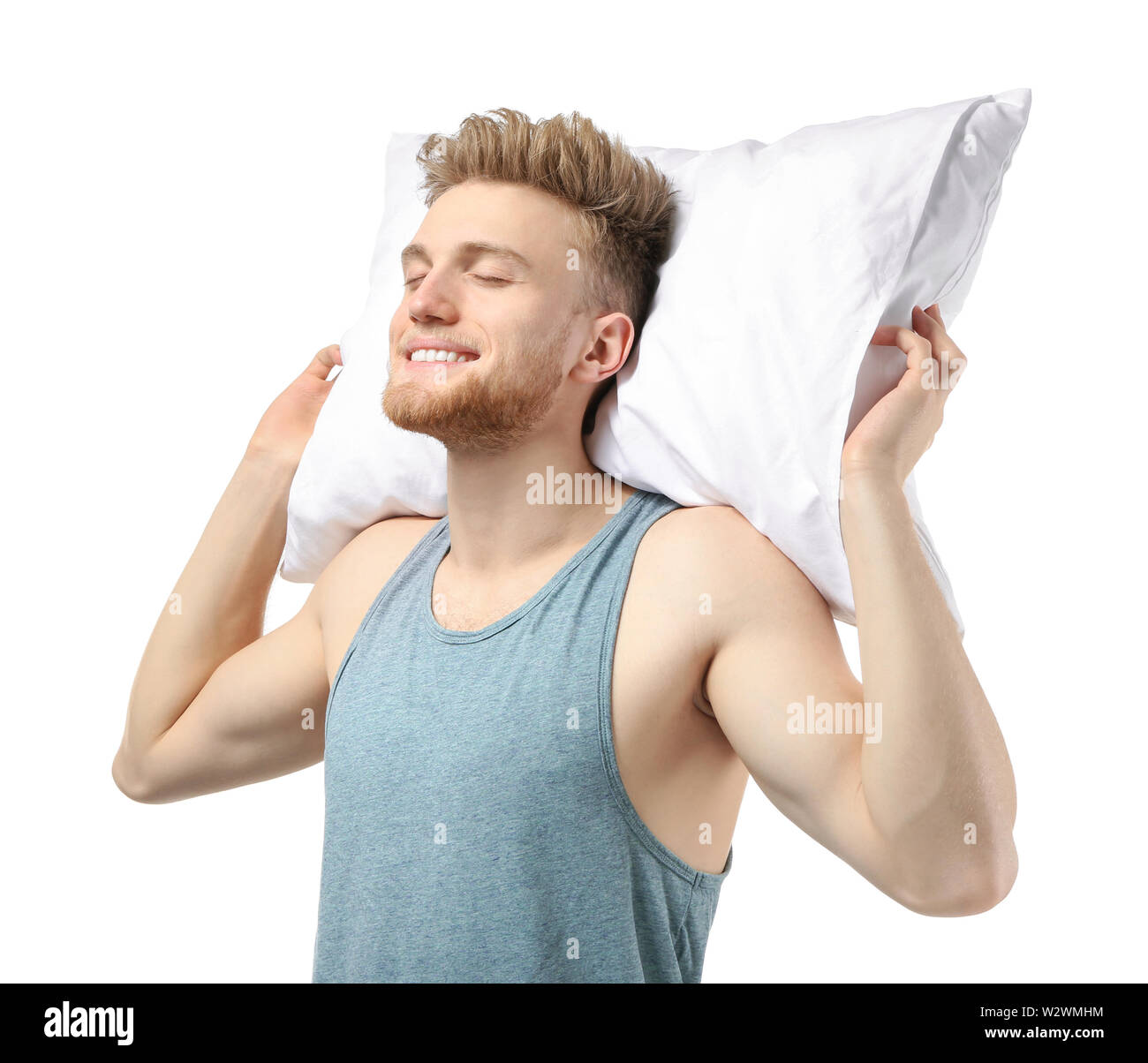 Handsome man with pillow on white background Stock Photo - Alamy