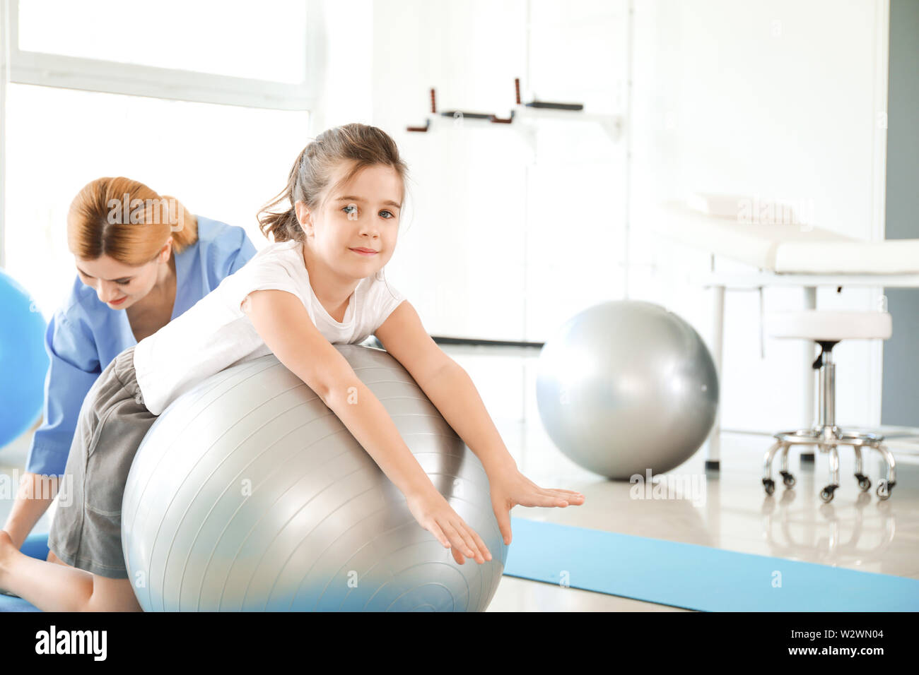 Physiotherapist working with little girl in rehabilitation center Stock ...