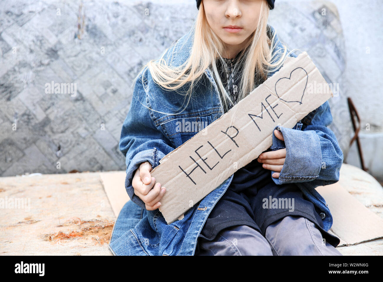 Homeless little girl begging for help outdoors Stock Photo - Alamy