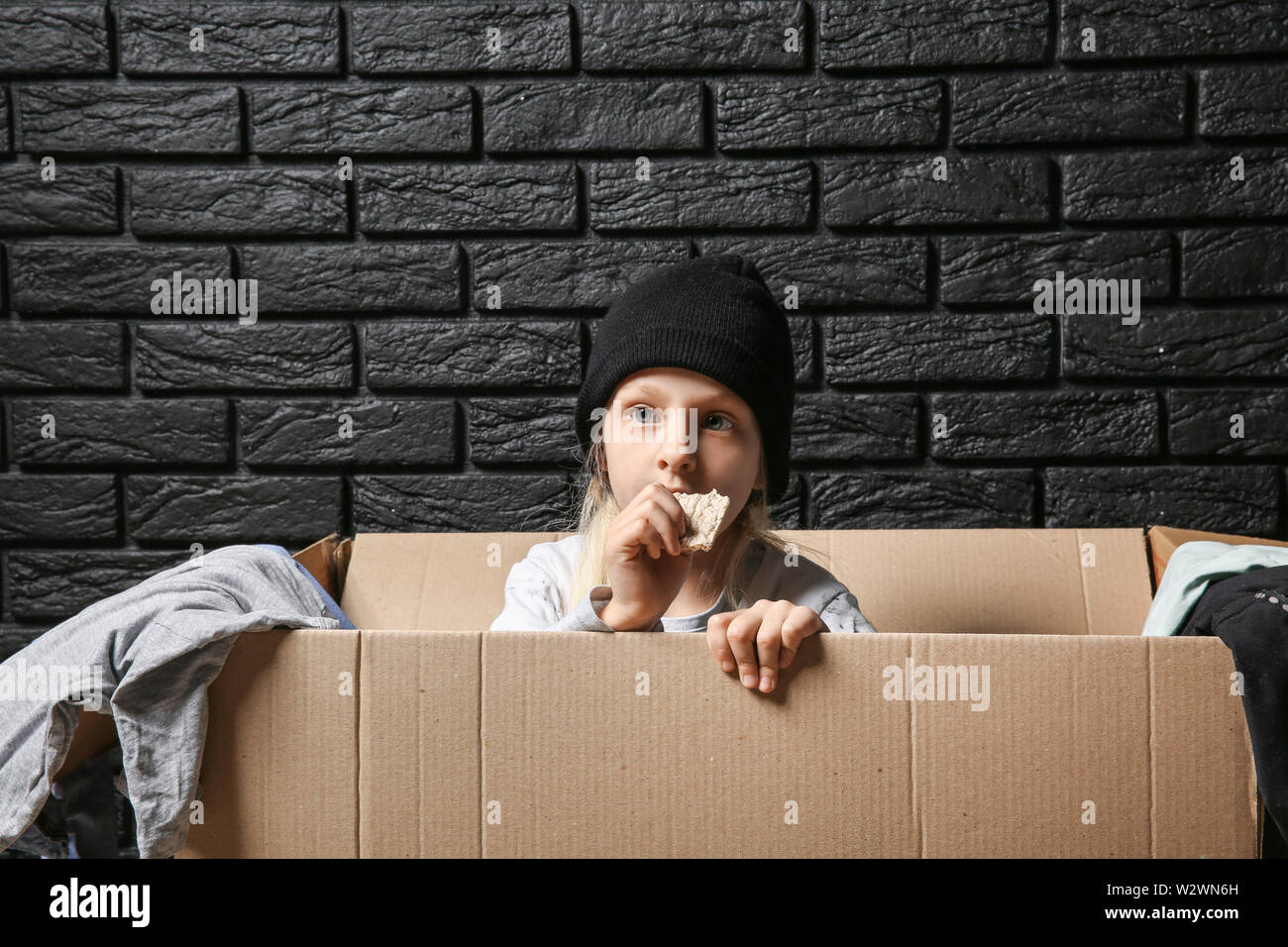 Cute homeless child sitting in hi-res stock photography and images - Alamy