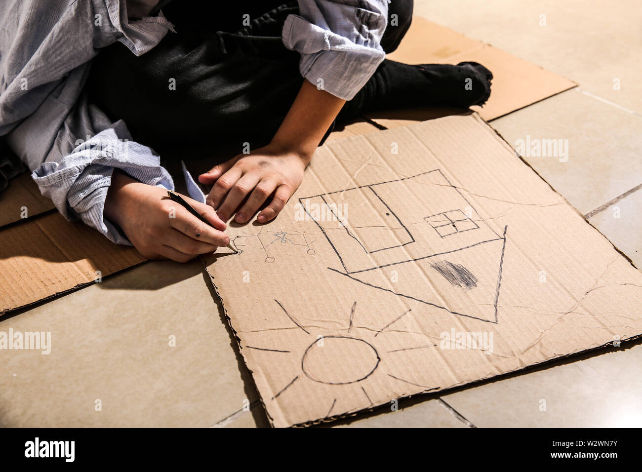 Homeless little boy dreaming about home Stock Photo - Alamy