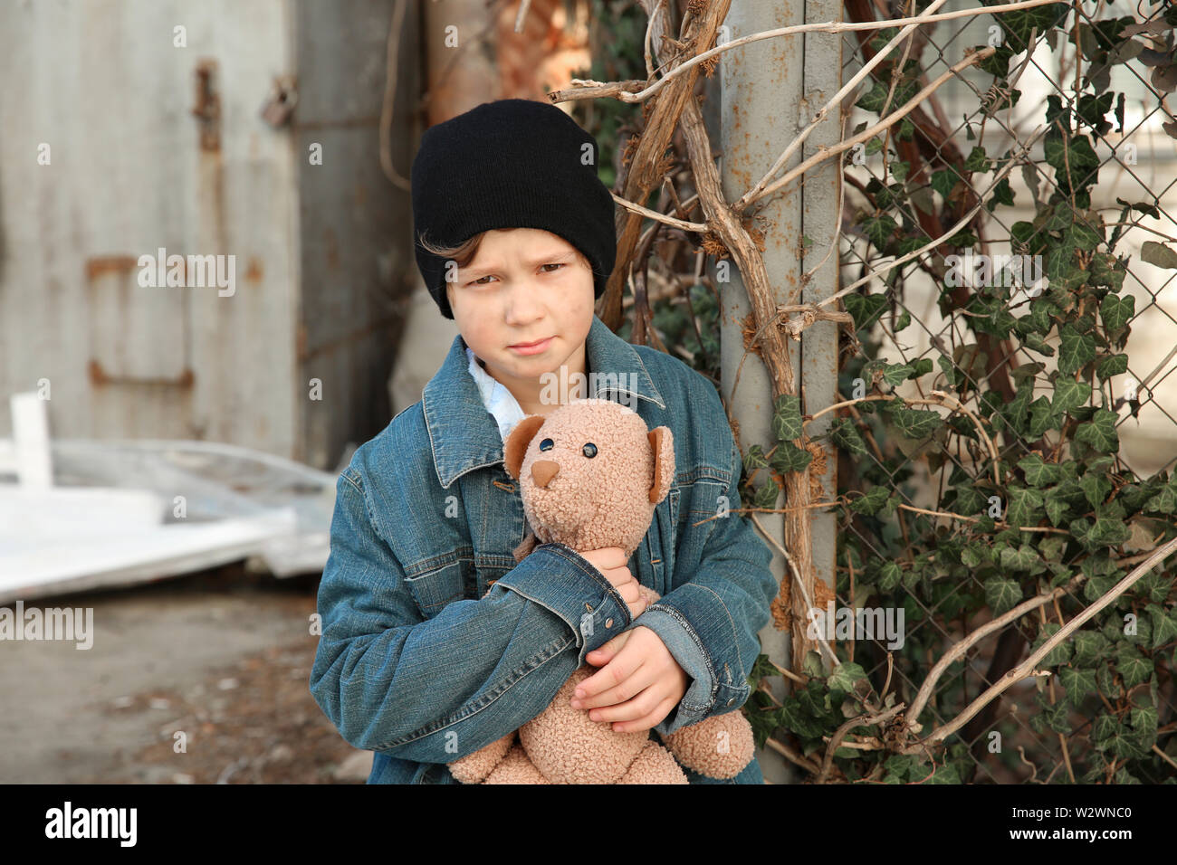 Homeless little boy with teddy bear outdoors Stock Photo - Alamy