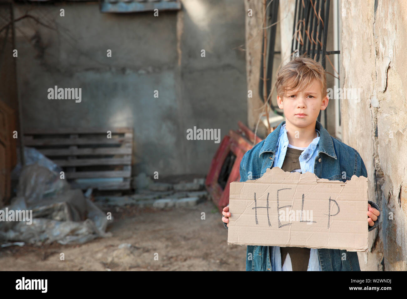 Homeless little boy begging for help outdoors Stock Photo - Alamy