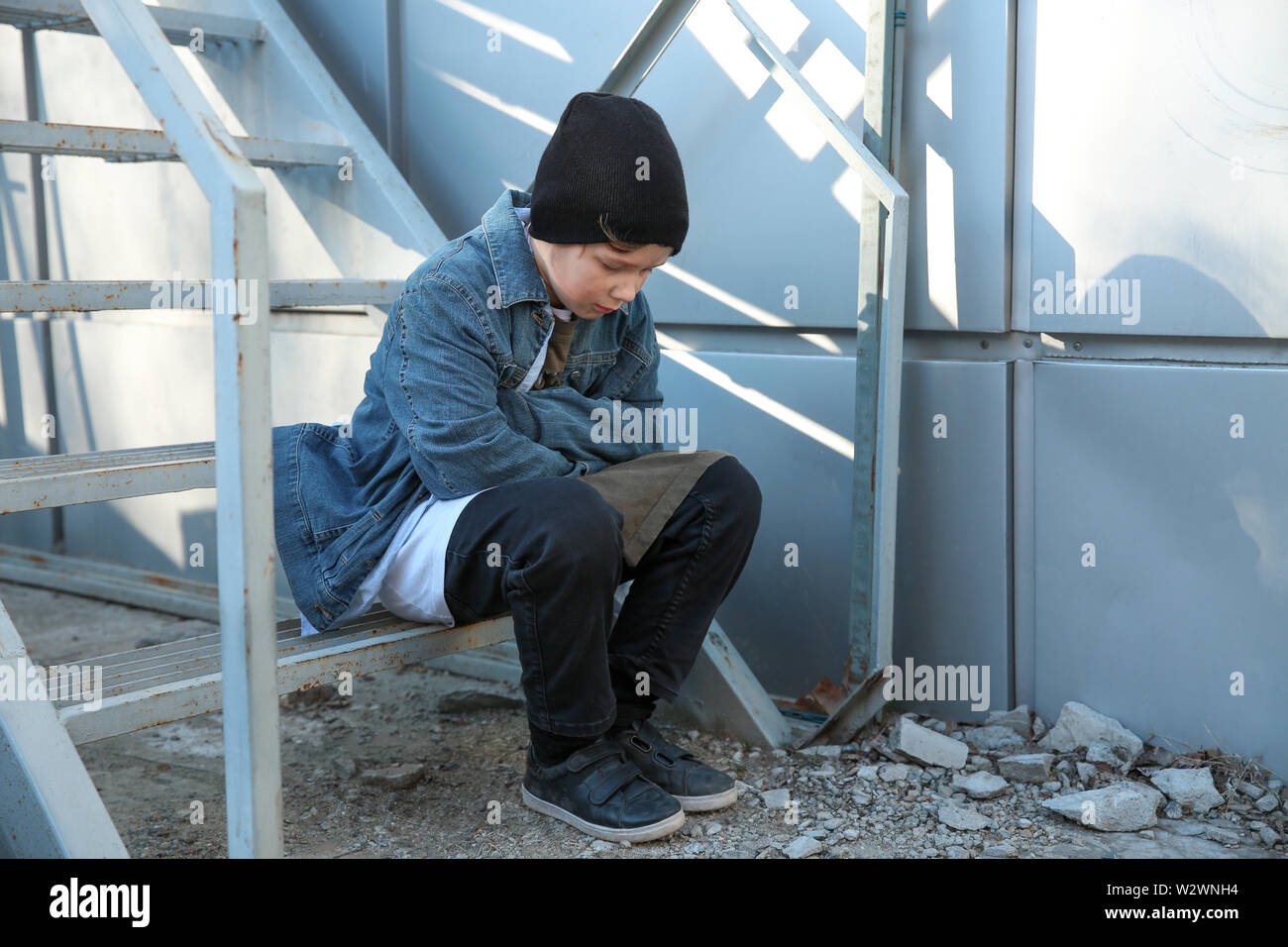 Homeless little boy outdoors Stock Photo - Alamy