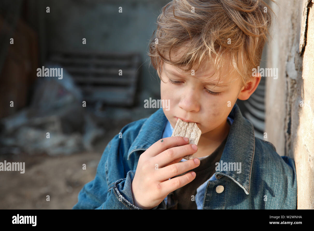 Homeless boy eating hi-res stock photography and images - Alamy