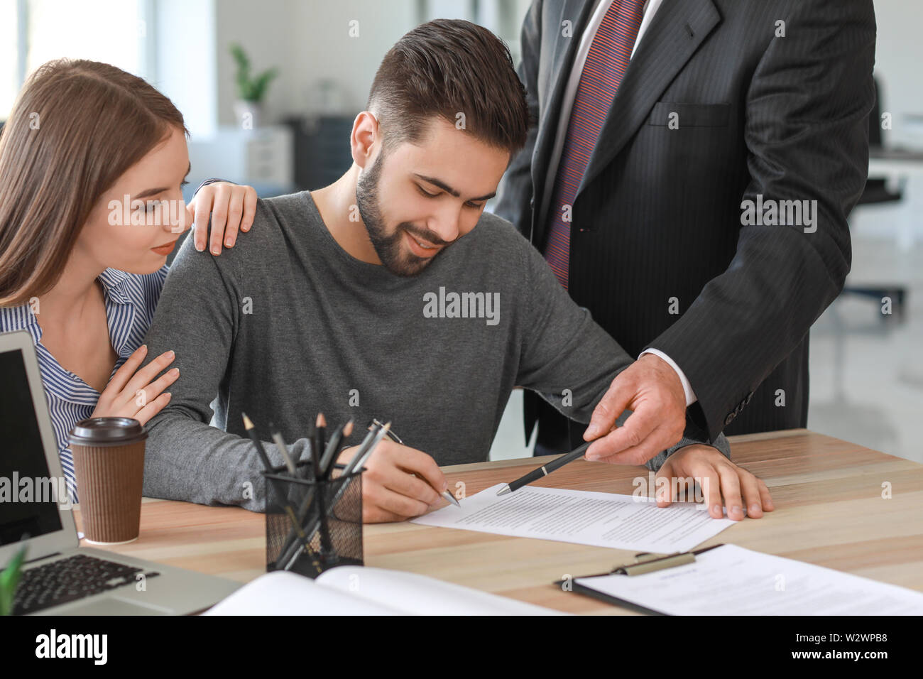 Couple signing documents at notary public office Stock Photo - Alamy