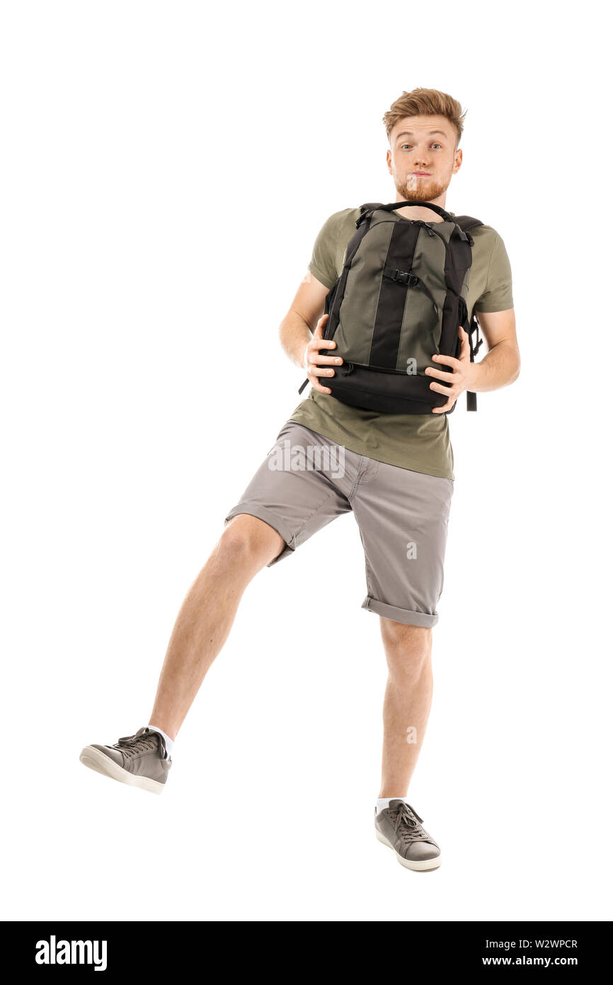Funny young tourist with heavy backpack on white background Stock Photo ...