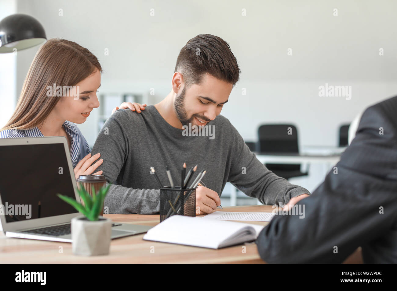 Couple signing documents at notary public office Stock Photo - Alamy
