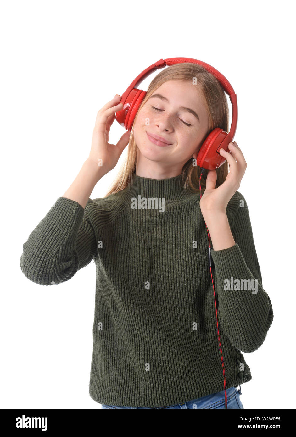 Cute teenage girl listening to music on white background Stock Photo ...