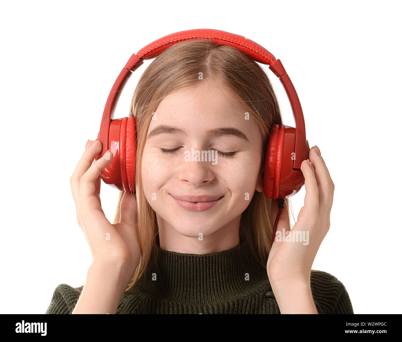 Cute teenage girl listening to music on white background Stock Photo ...